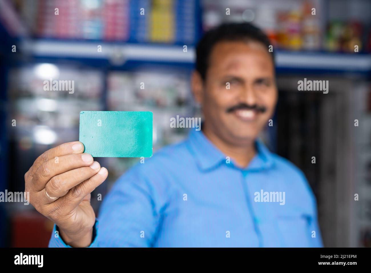 smiling medical owner showing green screen empty card by looking at ...