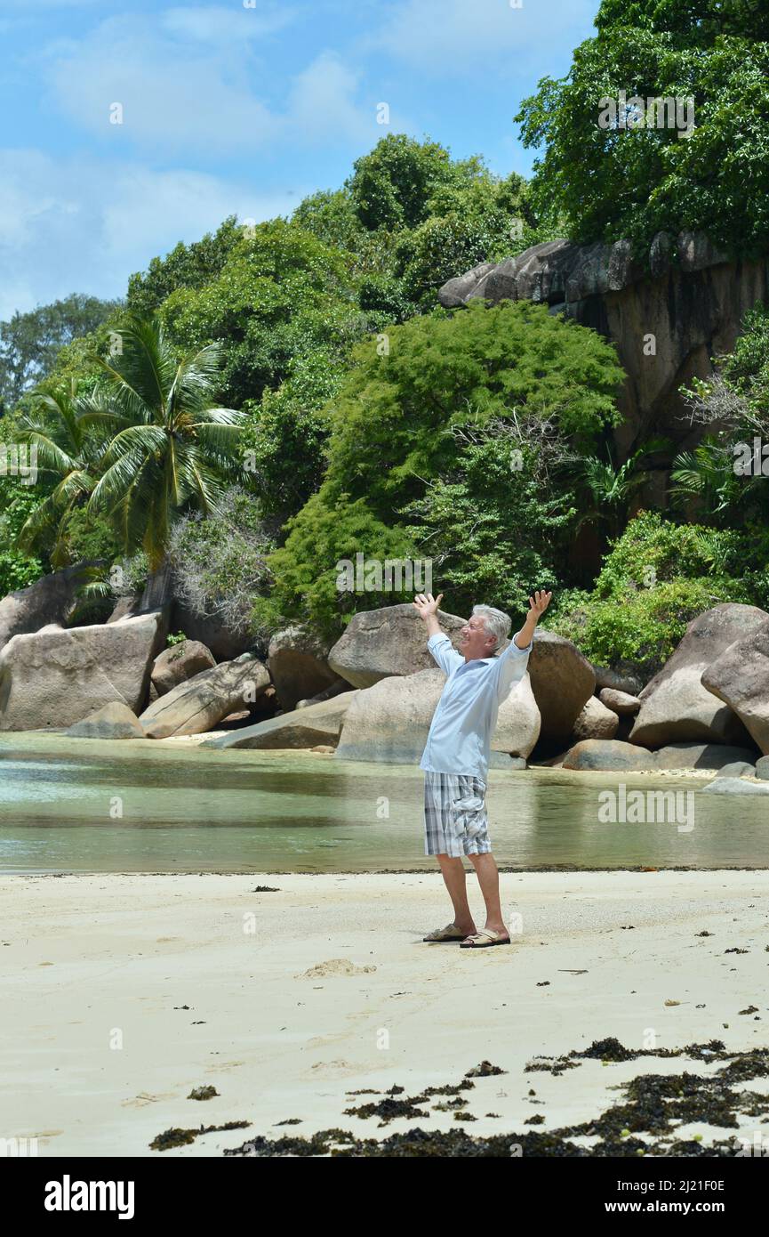 Happy beach man raised hands hi-res stock photography and images - Alamy