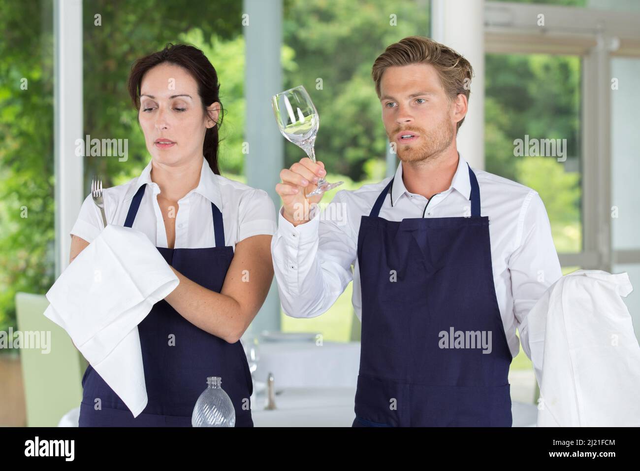 waiter and waitress polishing glass Stock Photo - Alamy