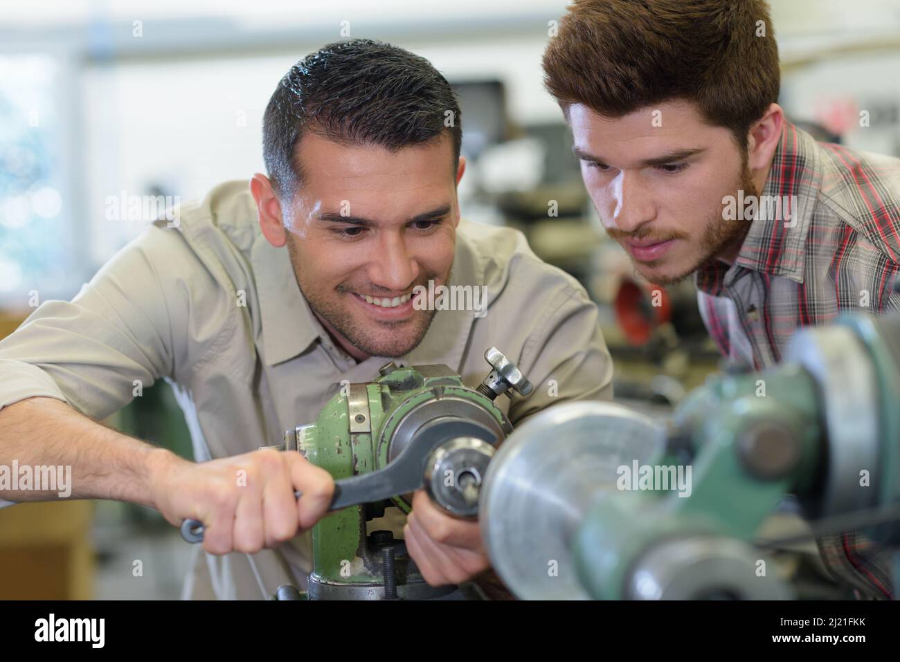 a portrait of supervisor instructing apprentices Stock Photo - Alamy