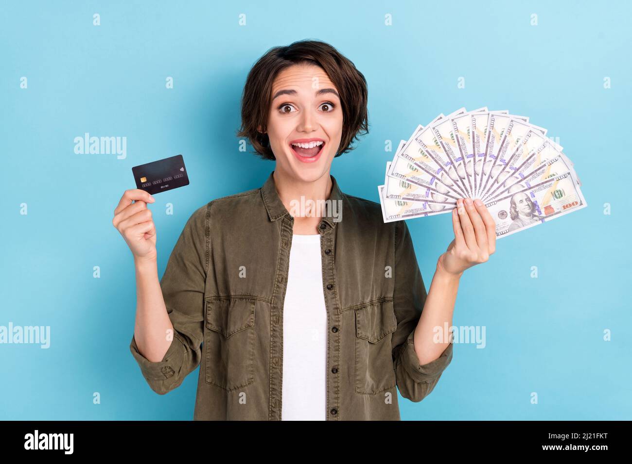 Photo of hooray young short hairstyle lady hold money card wear khaki ...