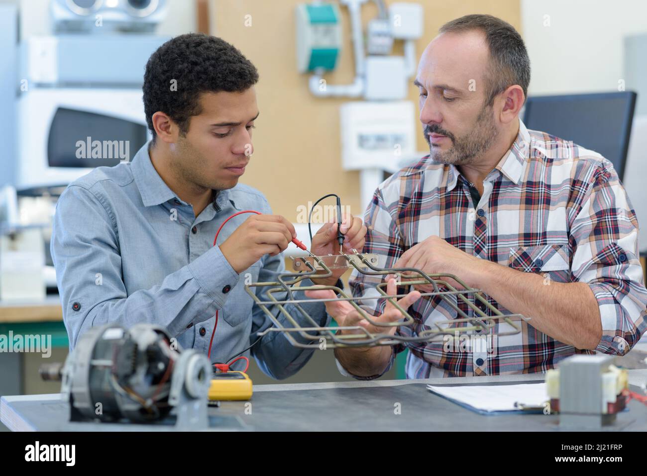 Two men repairing hi-res stock photography and images - Alamy