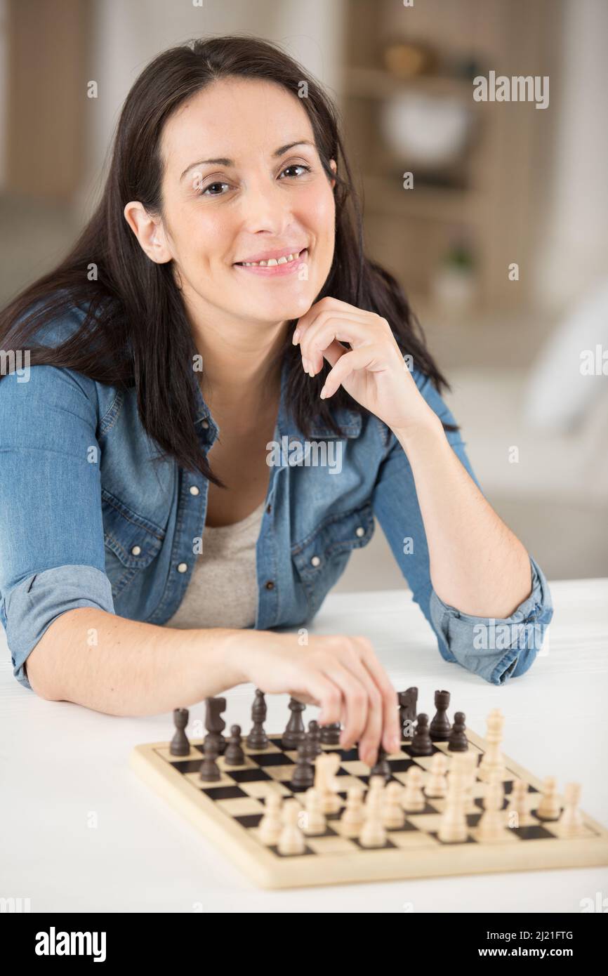 Smart woman playing chess home hi-res stock photography and images - Alamy