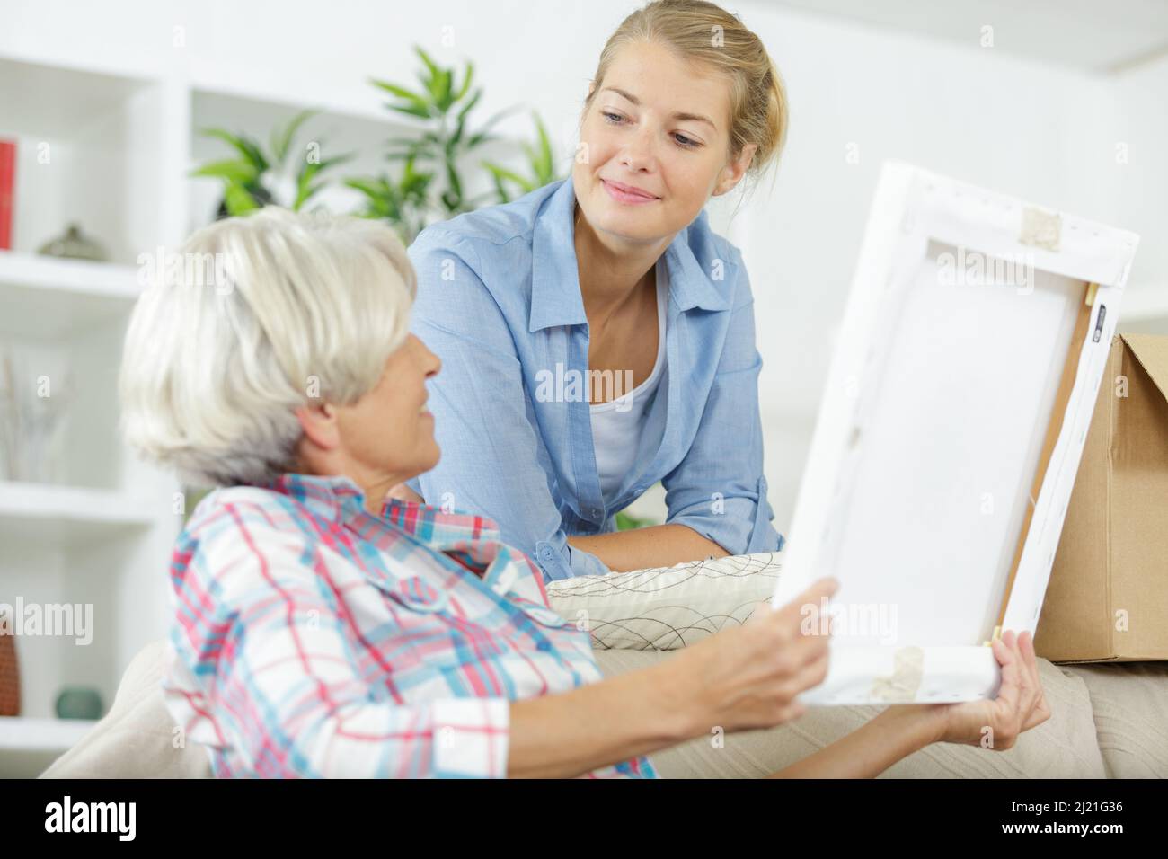 senior mum talks to younger daughter Stock Photo - Alamy