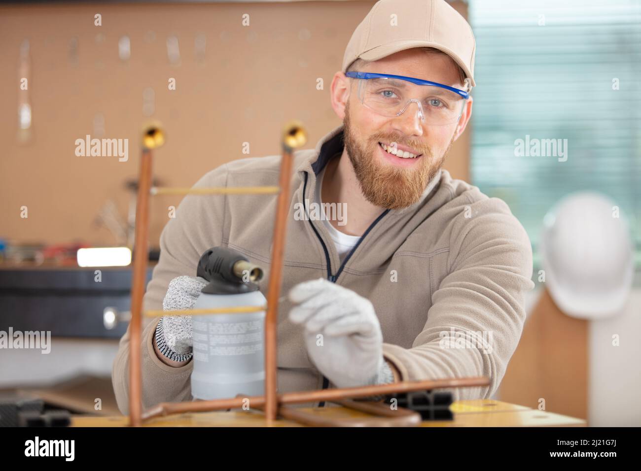 young man working on copper pipes Stock Photo - Alamy