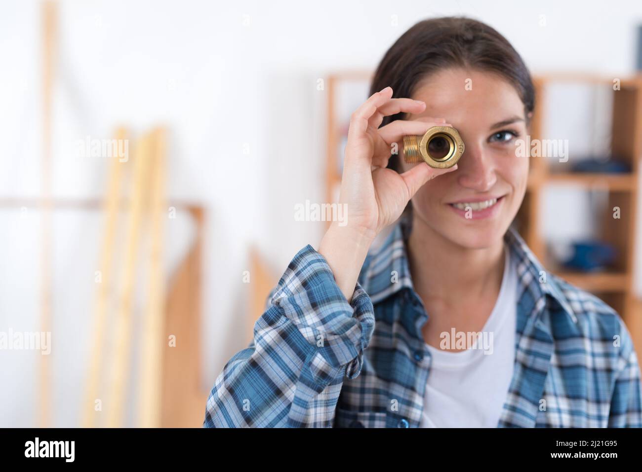 girl looking through a screw Stock Photo - Alamy