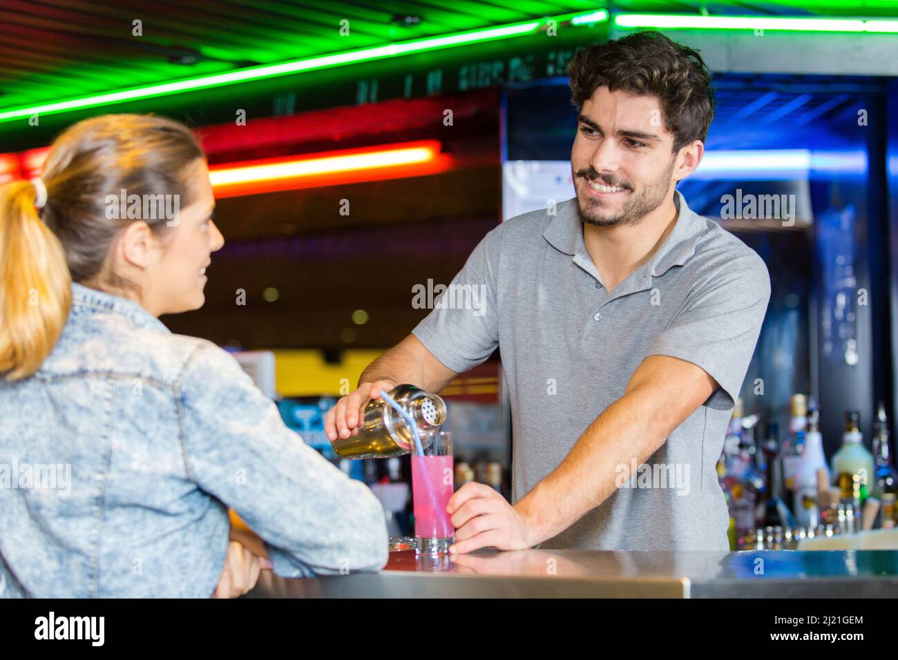 woman ordering from a bartender in a bar Stock Photo - Alamy