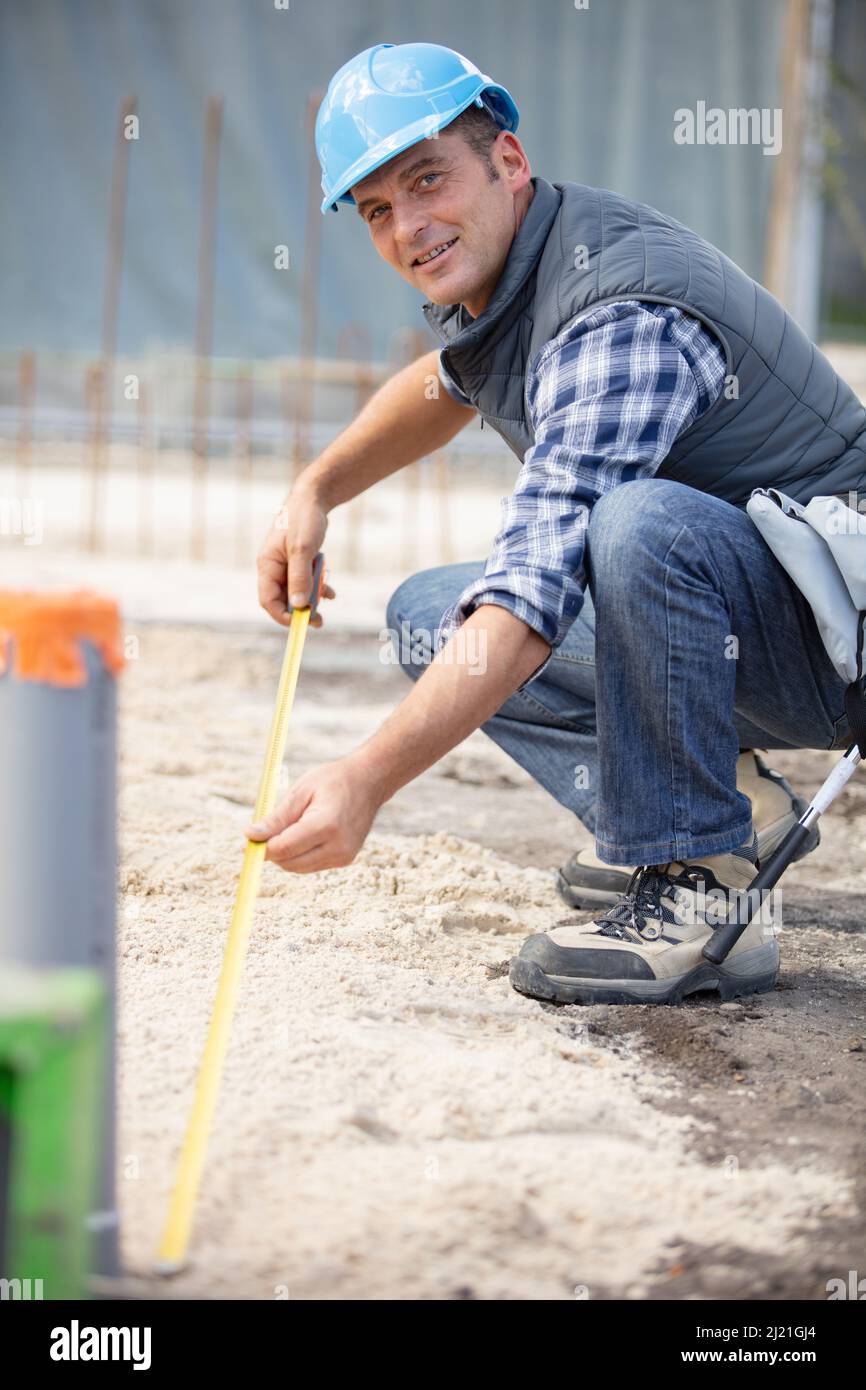 builder working outdoors at construction site Stock Photo - Alamy