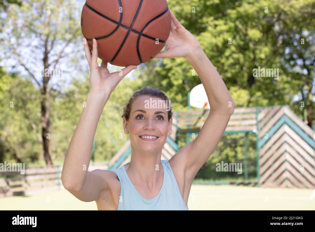 athletic female basketball player throwing a ball Stock Photo - Alamy