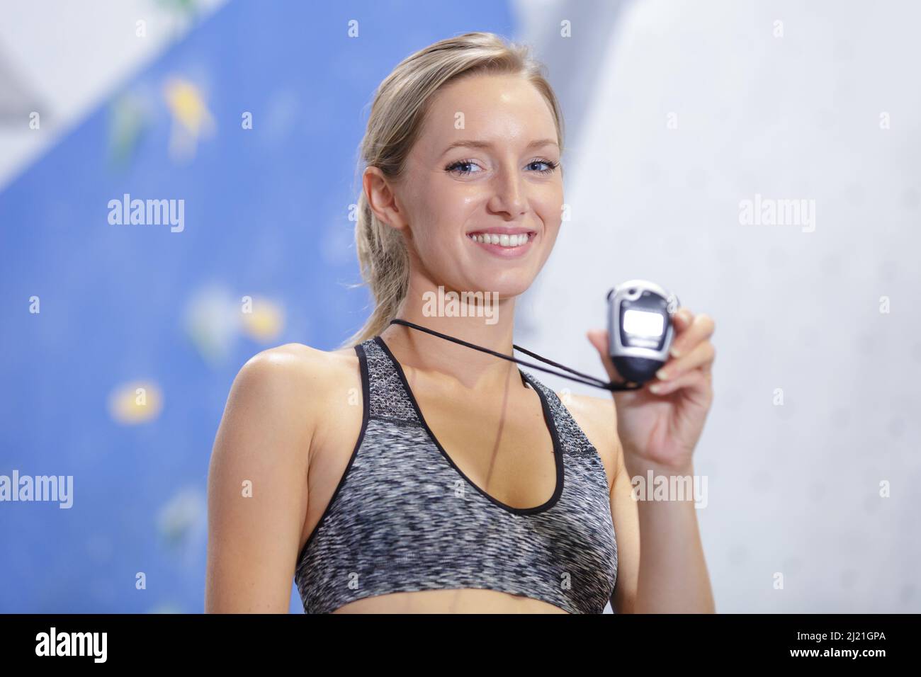 female wall climber holding chronometer Stock Photo - Alamy