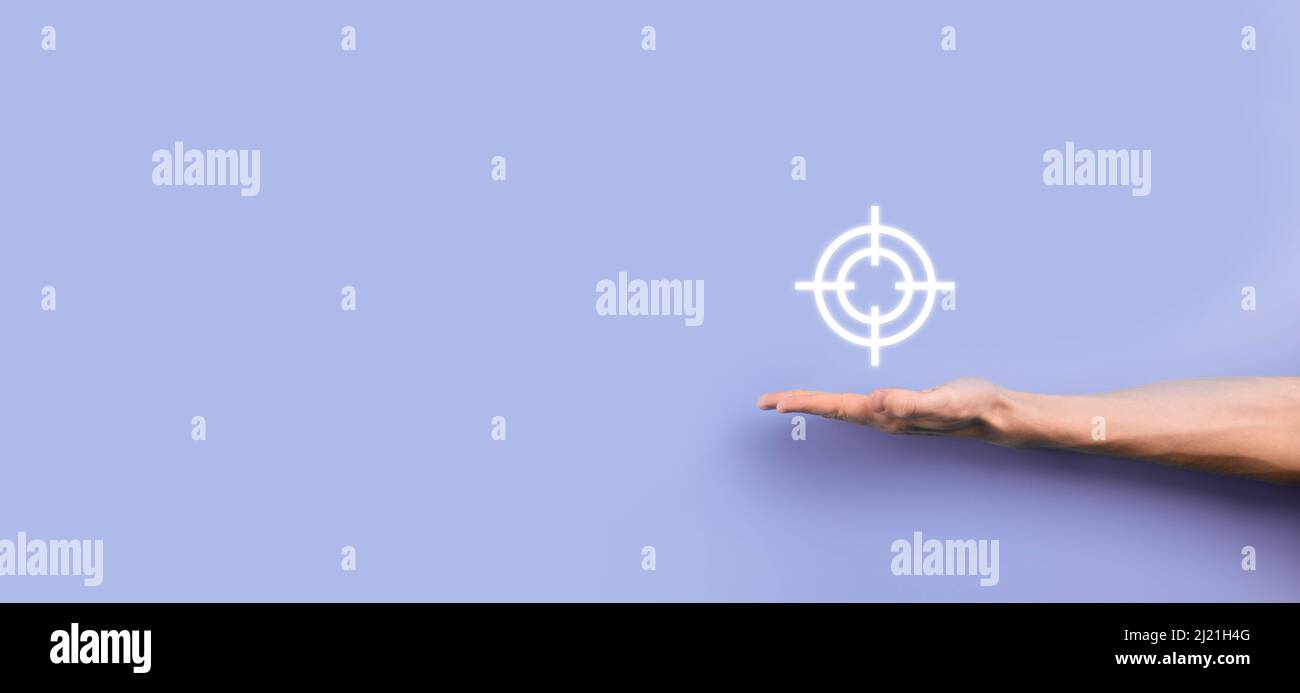 Targeting concept with businessman hand holding target icon dartboard ...