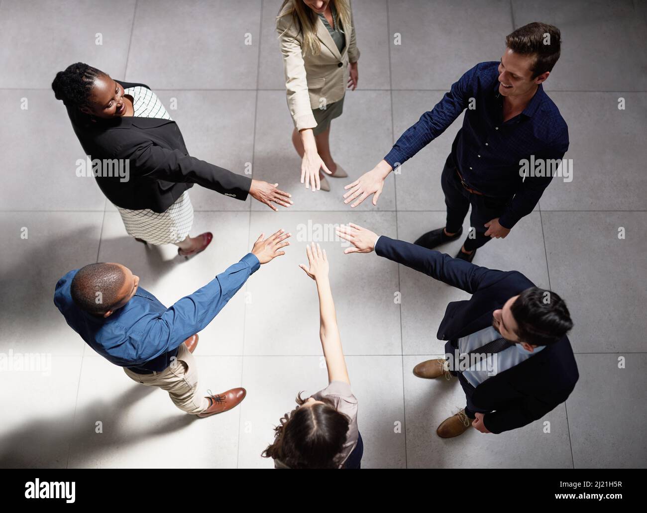 Reaching for greatness together. High angle shot of a group of ...