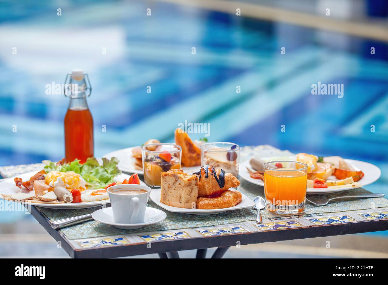 Table with delicious food by the beautiful blue pool travel in resort ...
