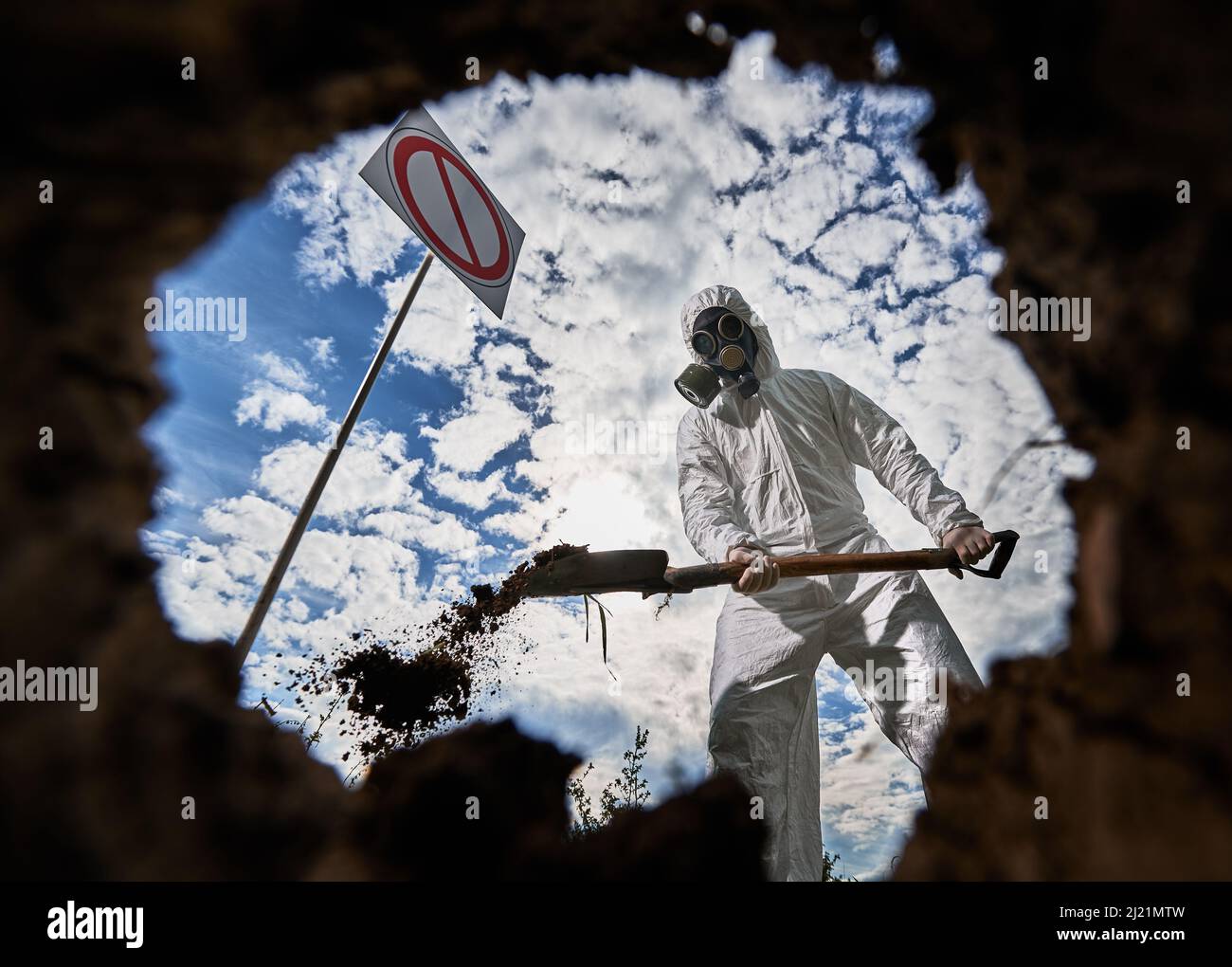View inside pit of scientist in white suit and gas mask standing near ...