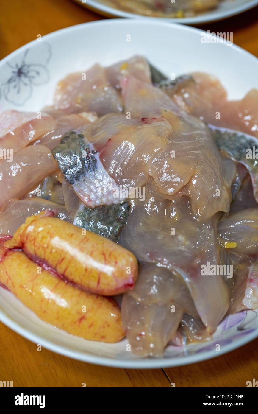 A fresh hot pot dish, raw and crispy fish fillets Stock Photo - Alamy