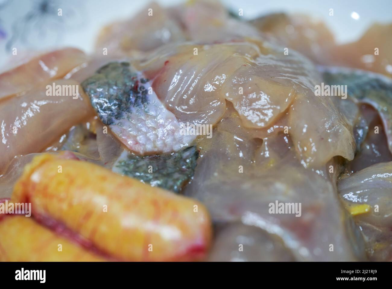 A fresh hot pot dish, raw and crispy fish fillets Stock Photo - Alamy