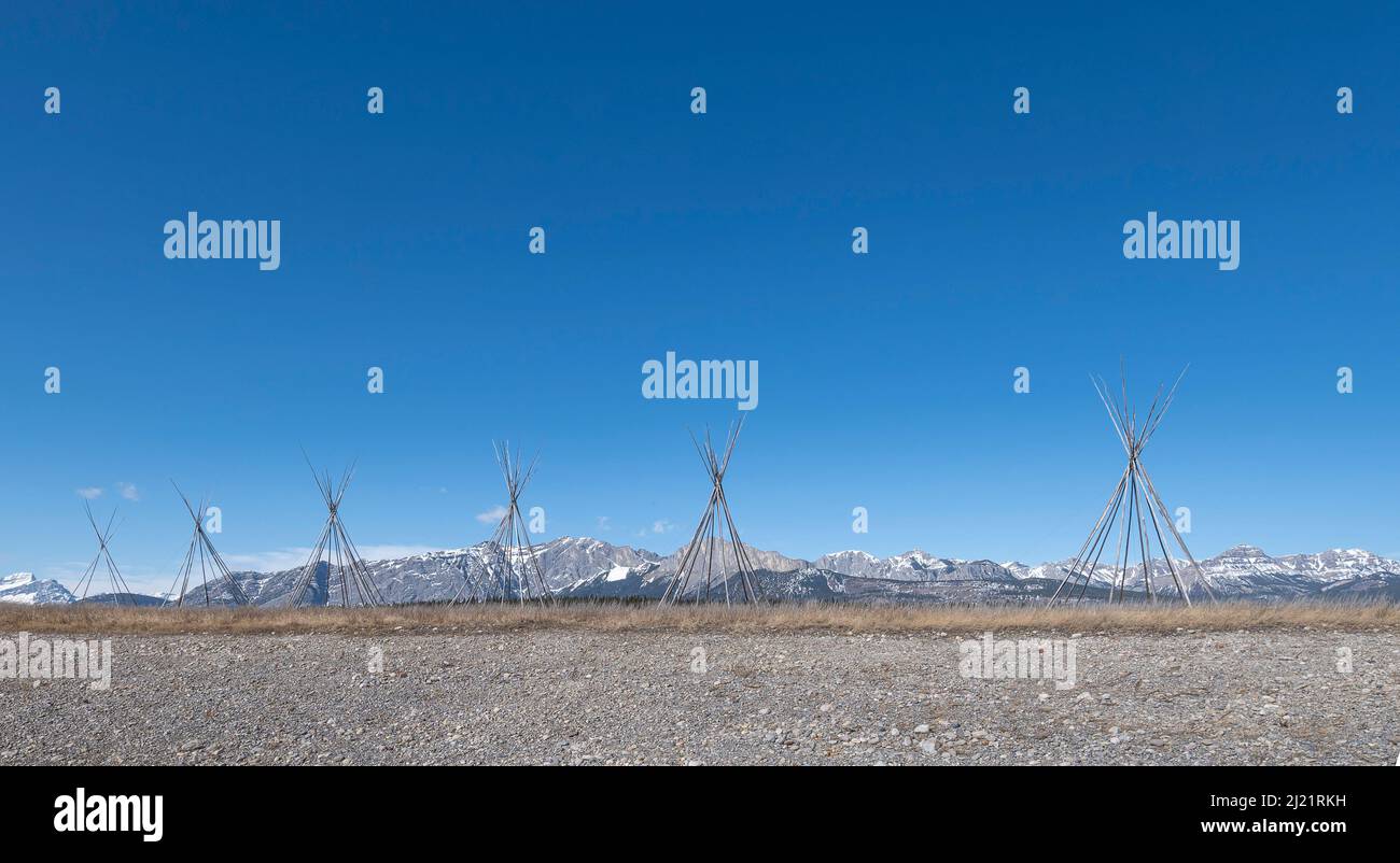 A row of tipi (teepee) frames on the Stoney Indian Reserve near Morley ...