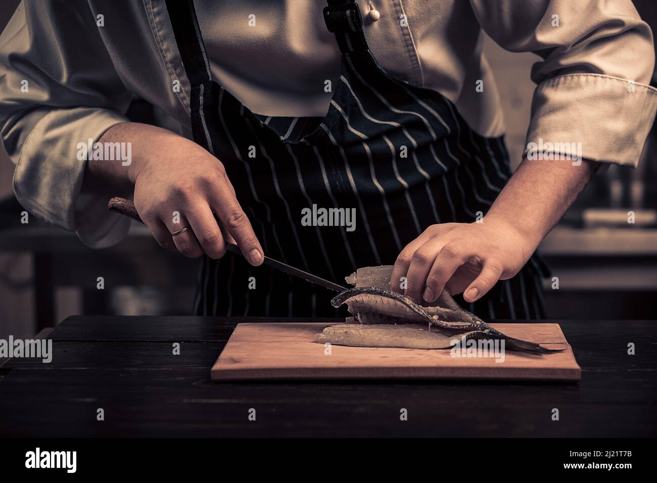 Chef cutting the fish on a board Stock Photo - Alamy