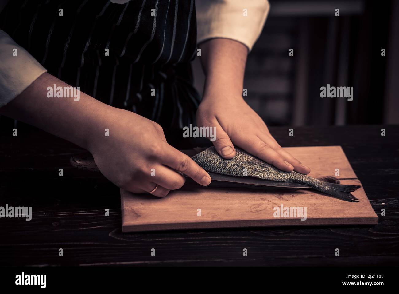 Chef cutting the fish on a board Stock Photo - Alamy