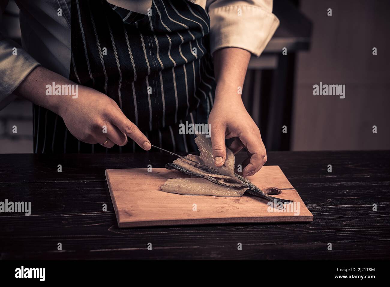 Chef cutting the fish on a board Stock Photo - Alamy