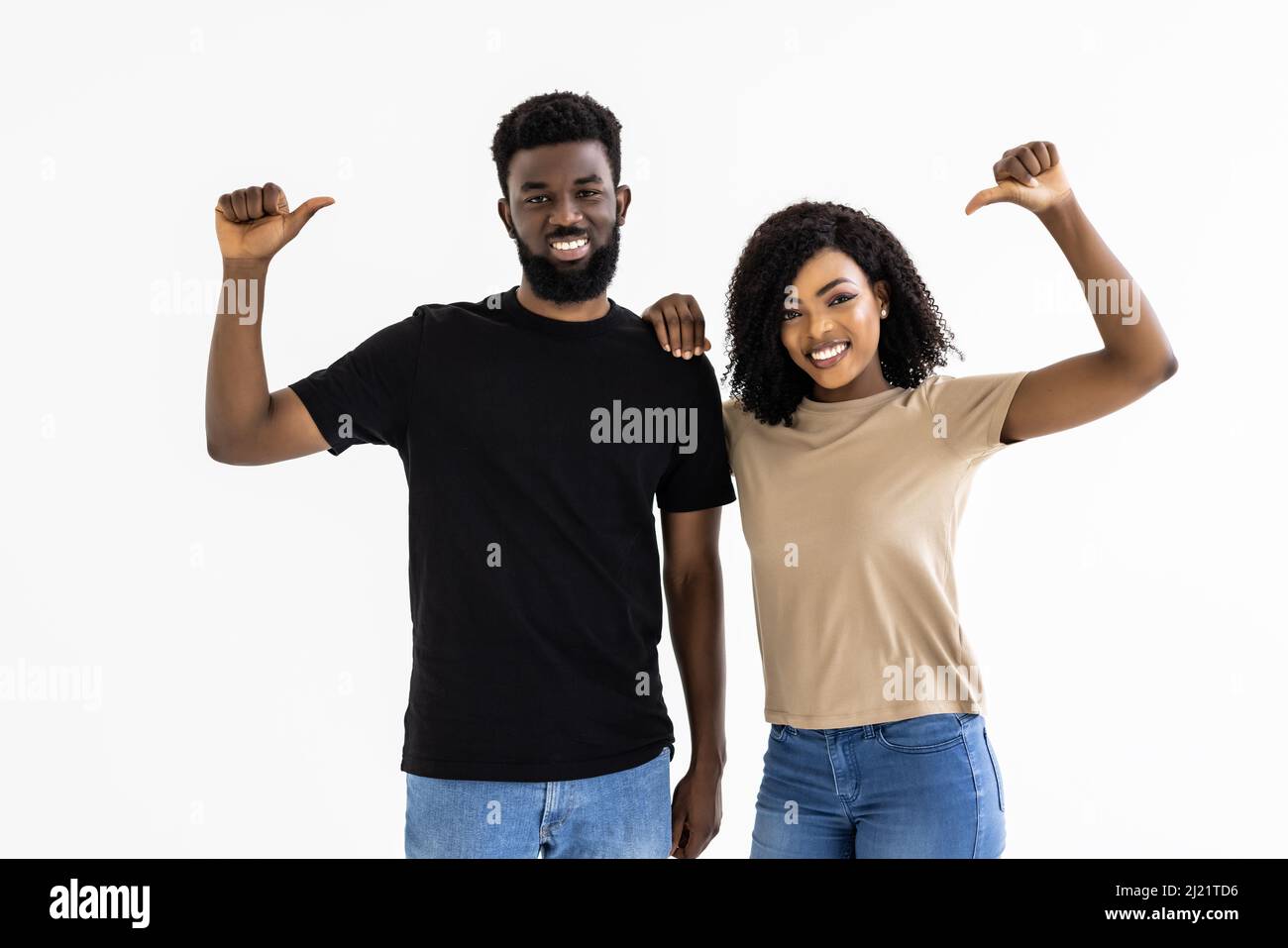 We made it. Joyful african couple celebrating success, raising fists ...