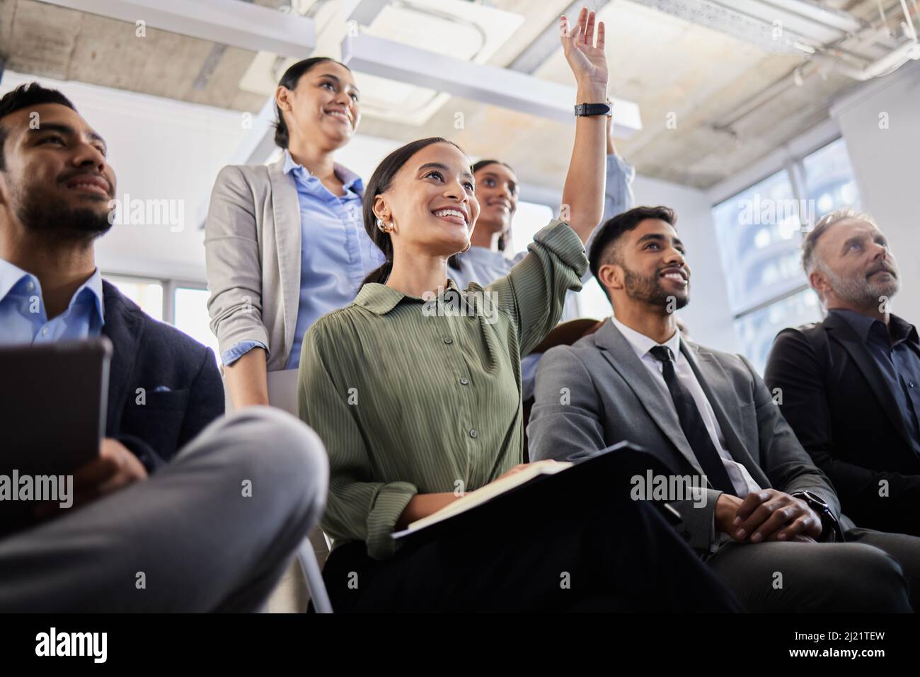 Waiting with baited breath. Shot of a group of business people asking ...
