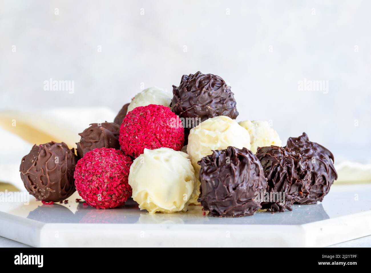 Truffle chocolate assortment on a white background. homemade chocolate ...