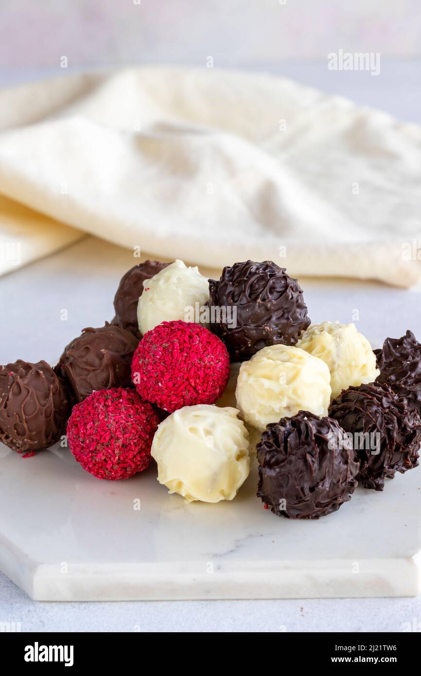 Truffle chocolate assortment on a white background. homemade chocolate ...