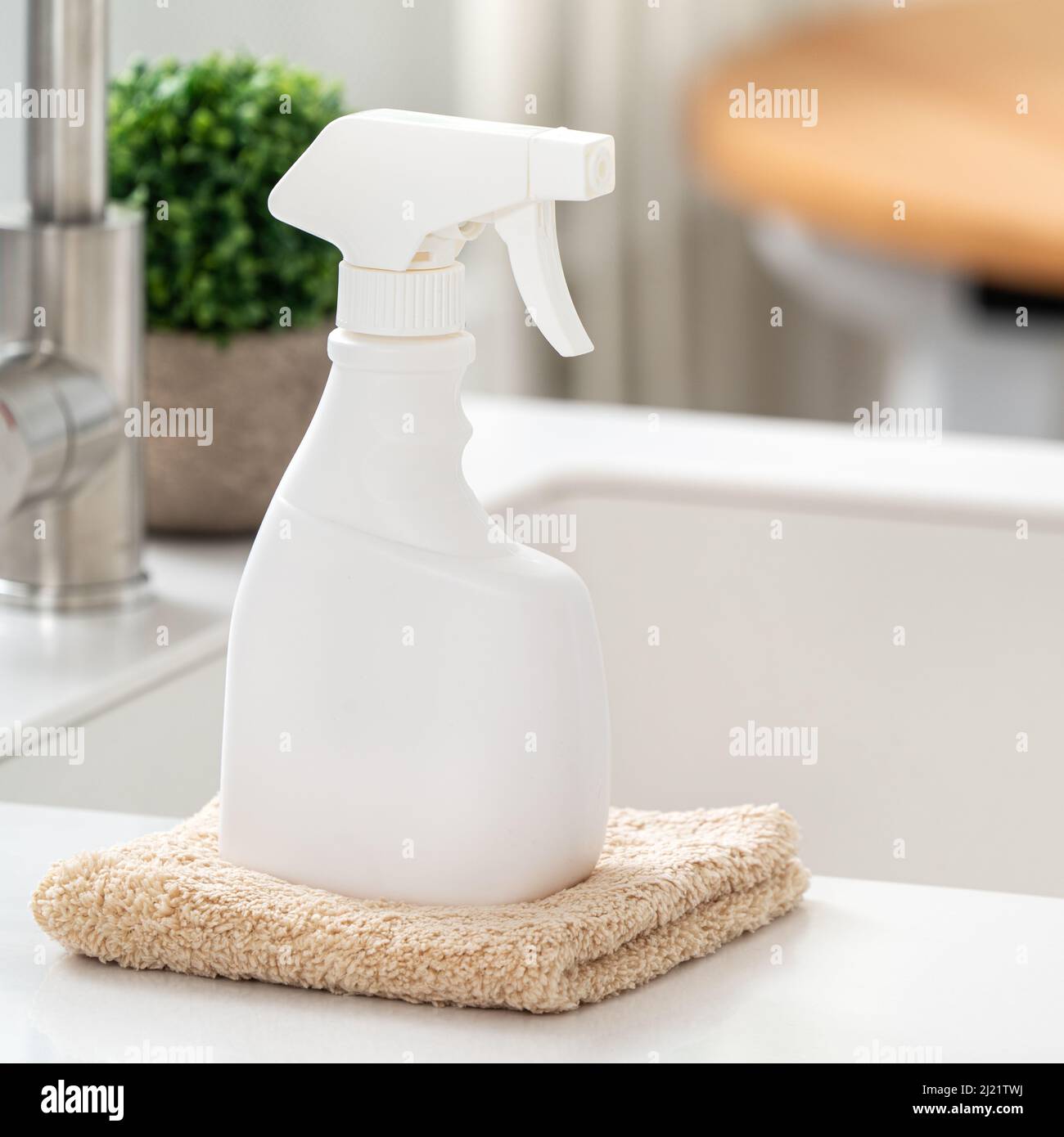 Concept of cleaning product spray bottle and rag in modern kitchen ...