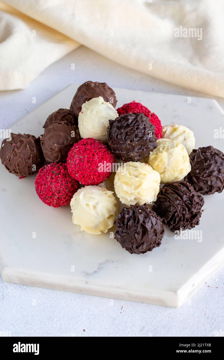 Truffle chocolate assortment on a white background. homemade chocolate ...