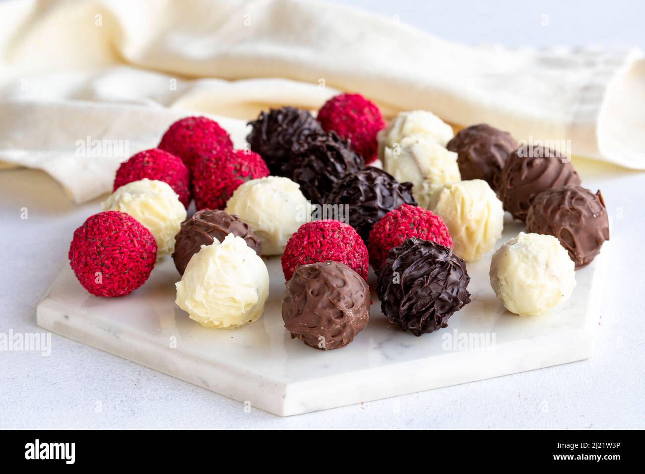 Truffle chocolate assortment on a white background. homemade chocolate ...
