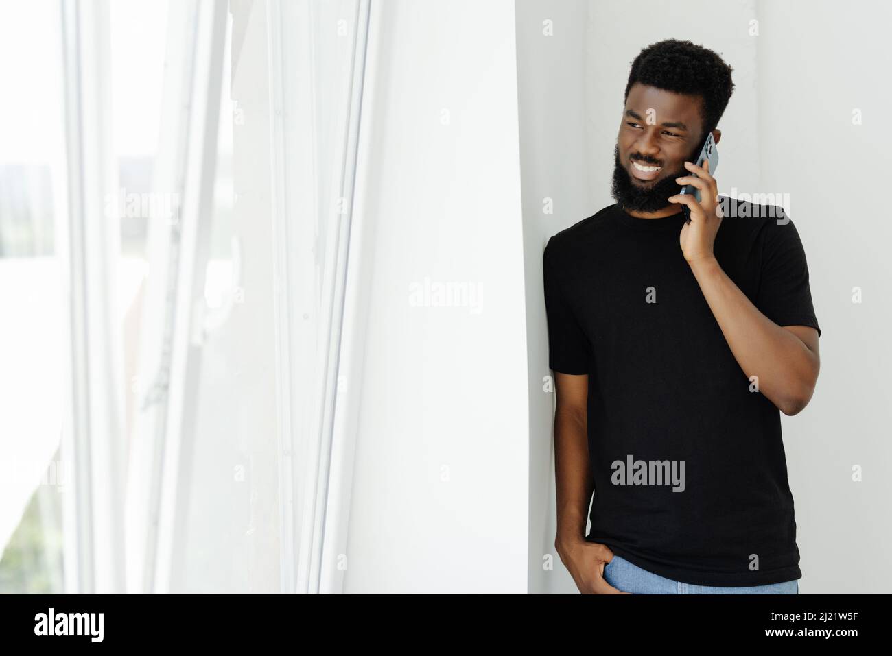 Portrait of african man talking on the phone isolated on a white ...