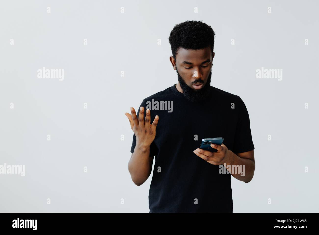 Condused black Afro African man use phone isolated over white ...