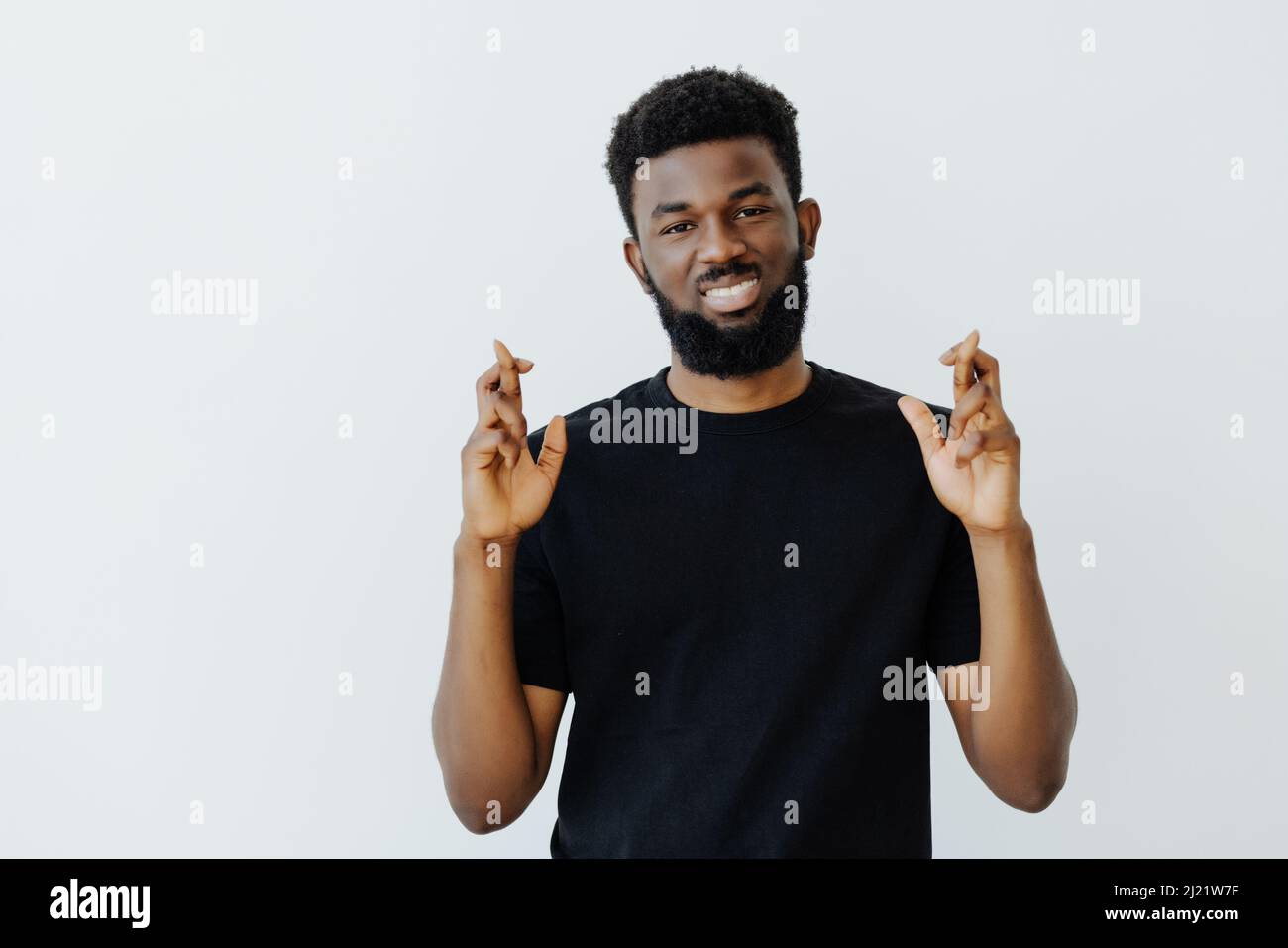 Handsome college student malestanding against white background with ...