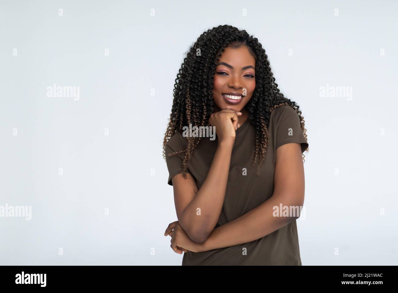 Portrait of beautiful young woman i holding her chin, trying to find ...