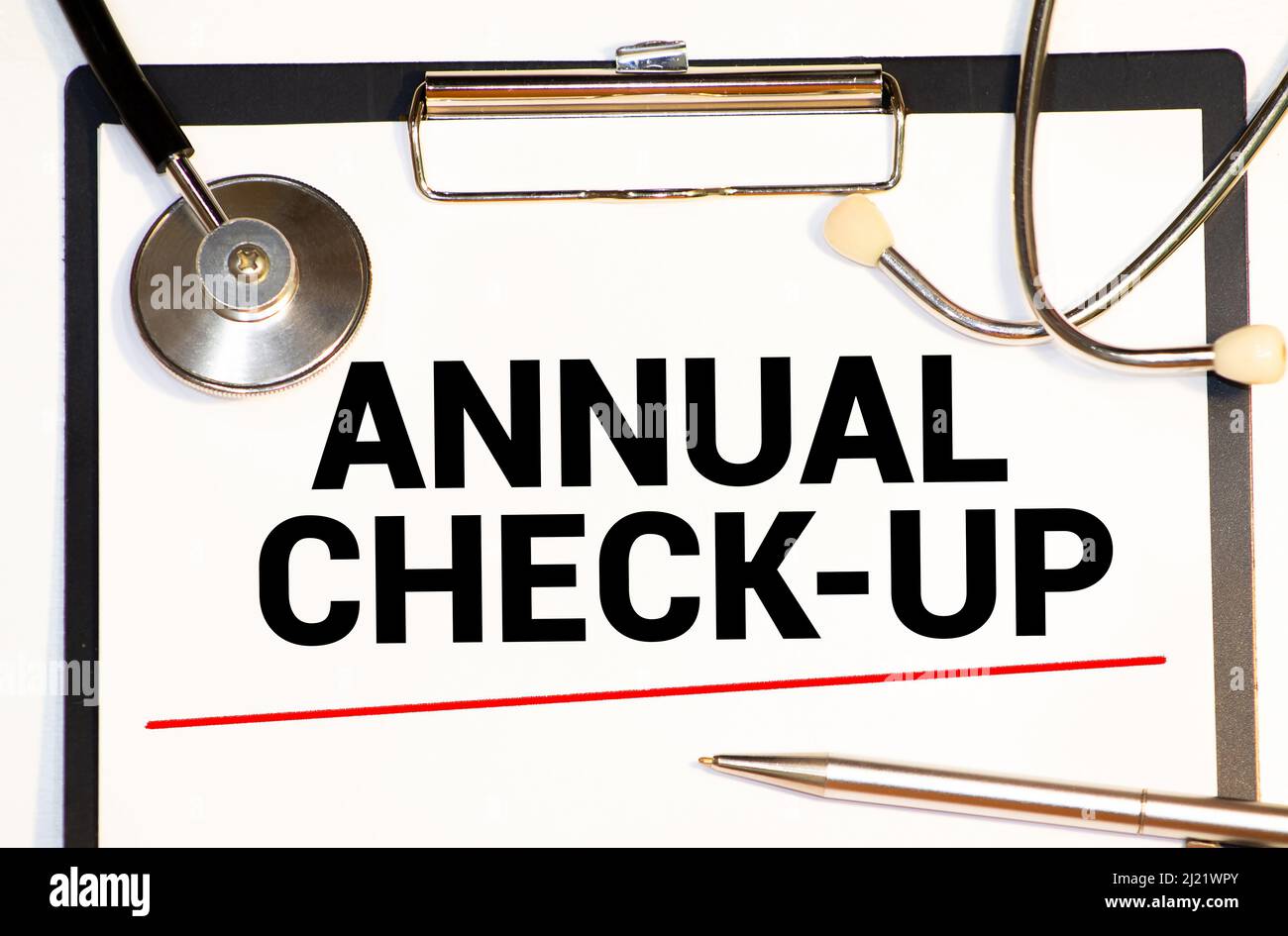Annual Check-up text on paper with heart beat diagram, stethoscope ...