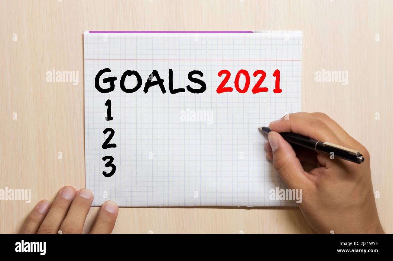 New year 2021 goals list. Office desk table with notebooks and pancil ...