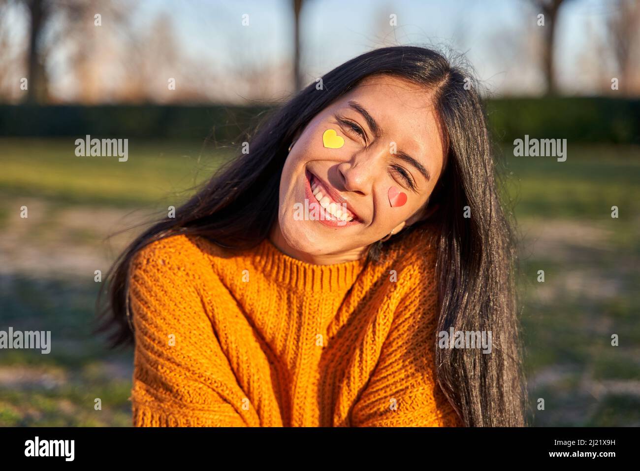 woman with hearts on her cheeks looking at the camera with her head ...