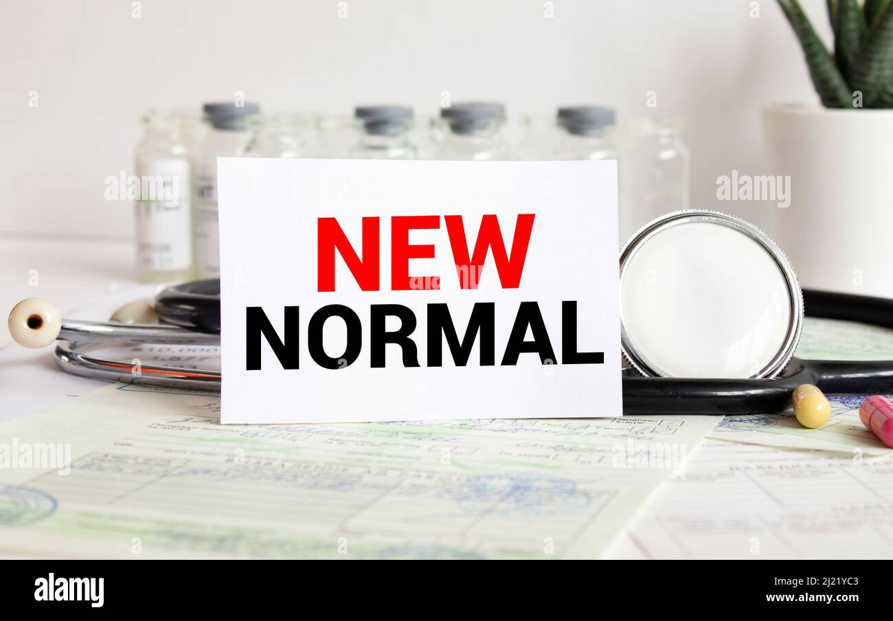 Keyboard, pen, magnifier glass and book written with New Normal. World ...