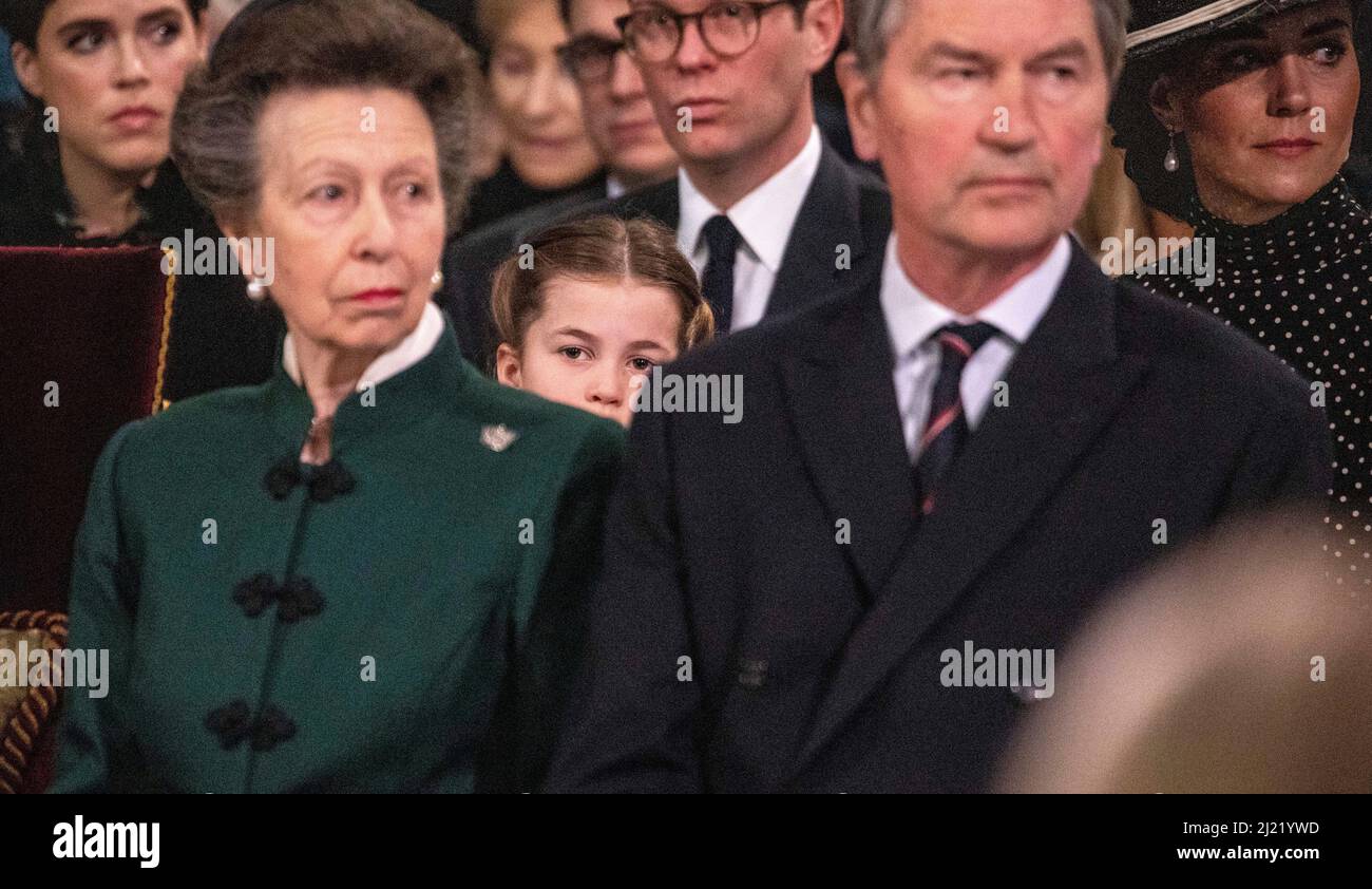 Princess Charlotte peers out from her seat between Princess Anne and ...