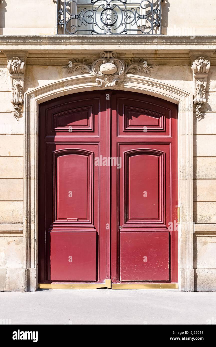 Paris, a red wooden door, typical building in the 7th arrondissement, a ...