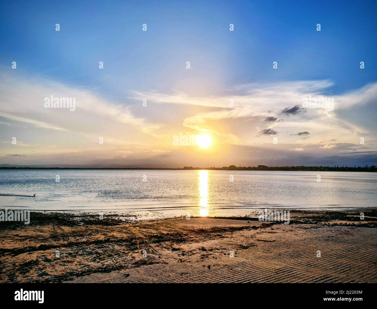 A breathtaking view from a beach with the bright sun in the sky Stock ...
