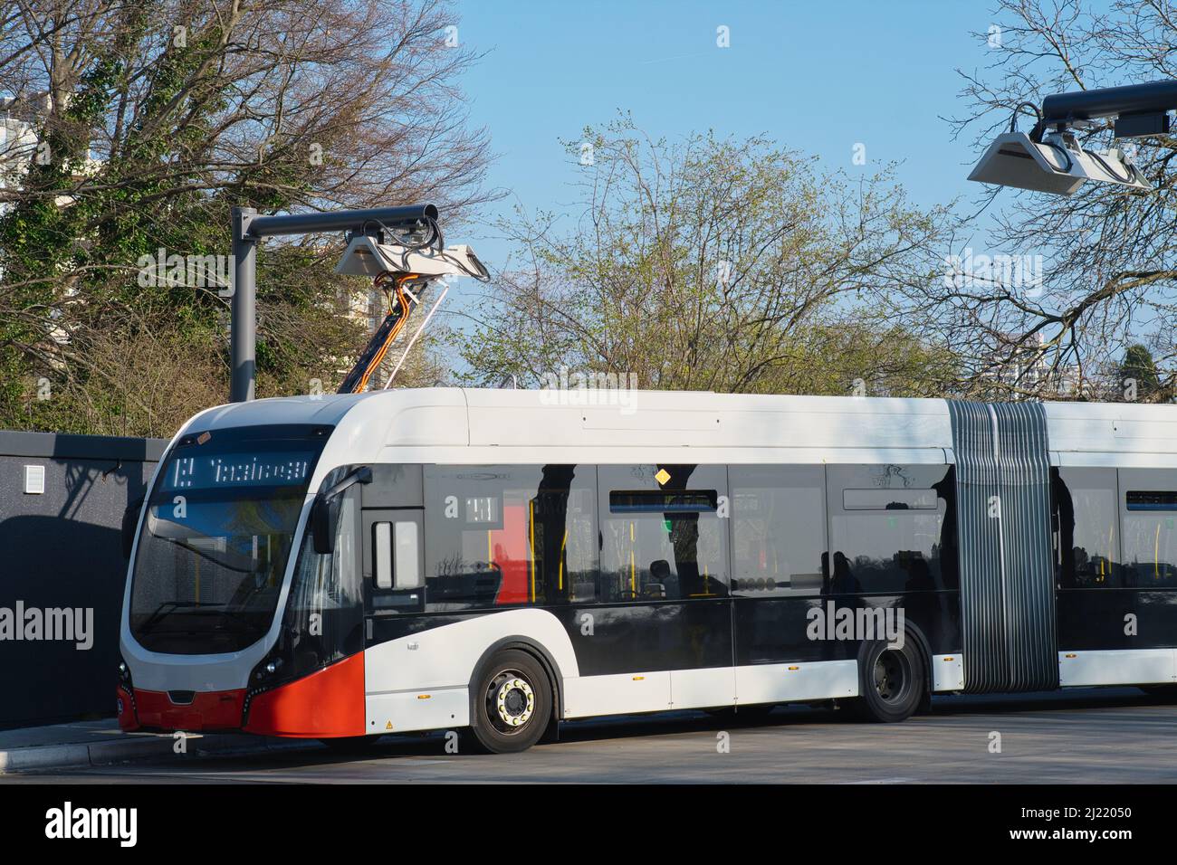 A large electric bus charging at a charging station,drive of the future ...
