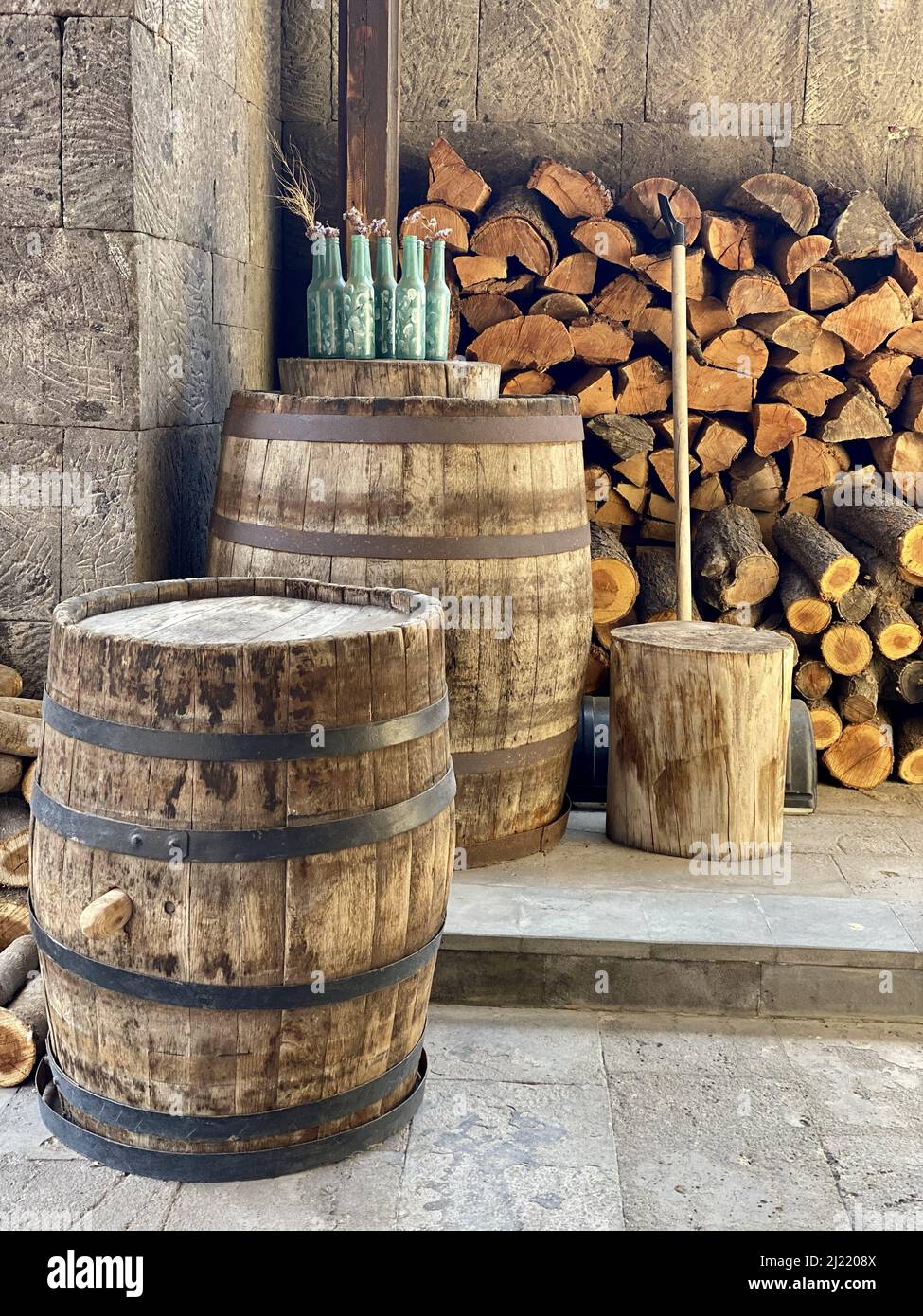 Vintage wooden barrels and chopped wood next to the wall Stock Photo ...