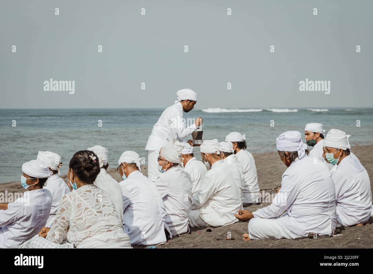 Hindu Priest blessing people with holy water. Balinese Hindus perform ...