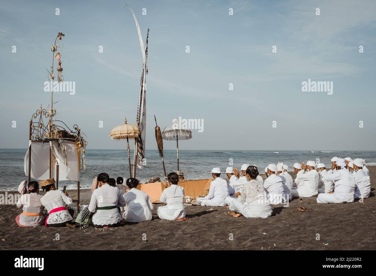 Balinese Hindu praying by the ocean. Balinese Hindus perform ...