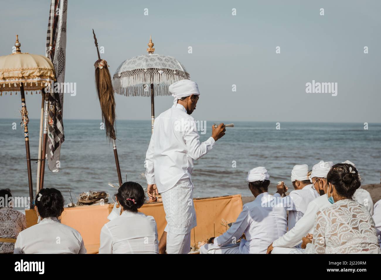 Balinese Hindu praying by the ocean. Balinese Hindus perform ...