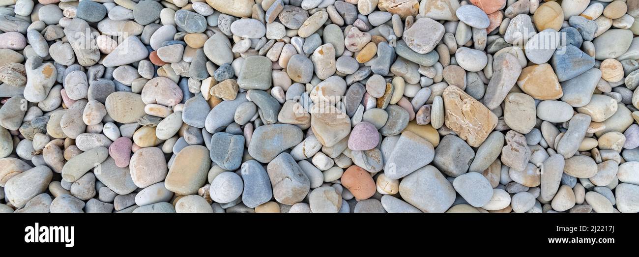 Pebble beach on the beach, colorful background Stock Photo - Alamy