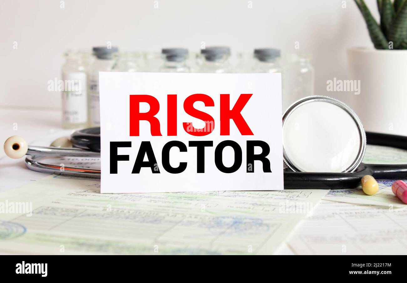 Risk factor words written on medical blue folder with patient files ...