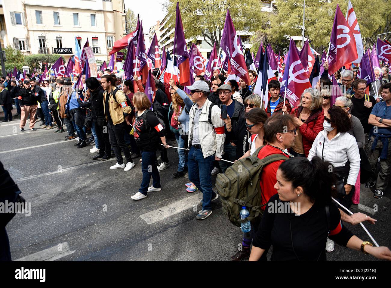 Popular Union activists march through the streets while holding flags ...